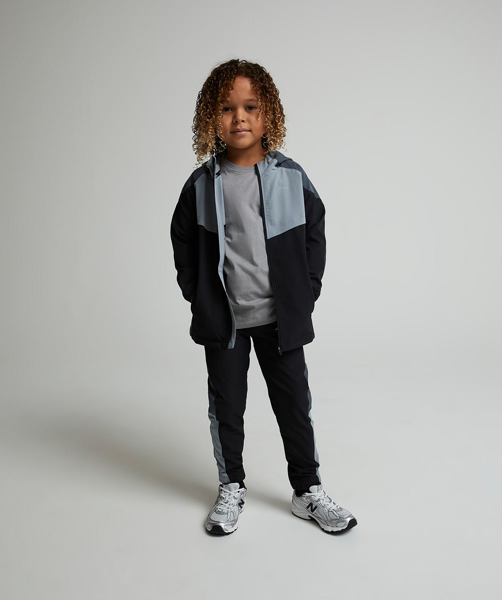Nursery Triton Woven Tracksuit | Jet Black / Irongate / Monument ...